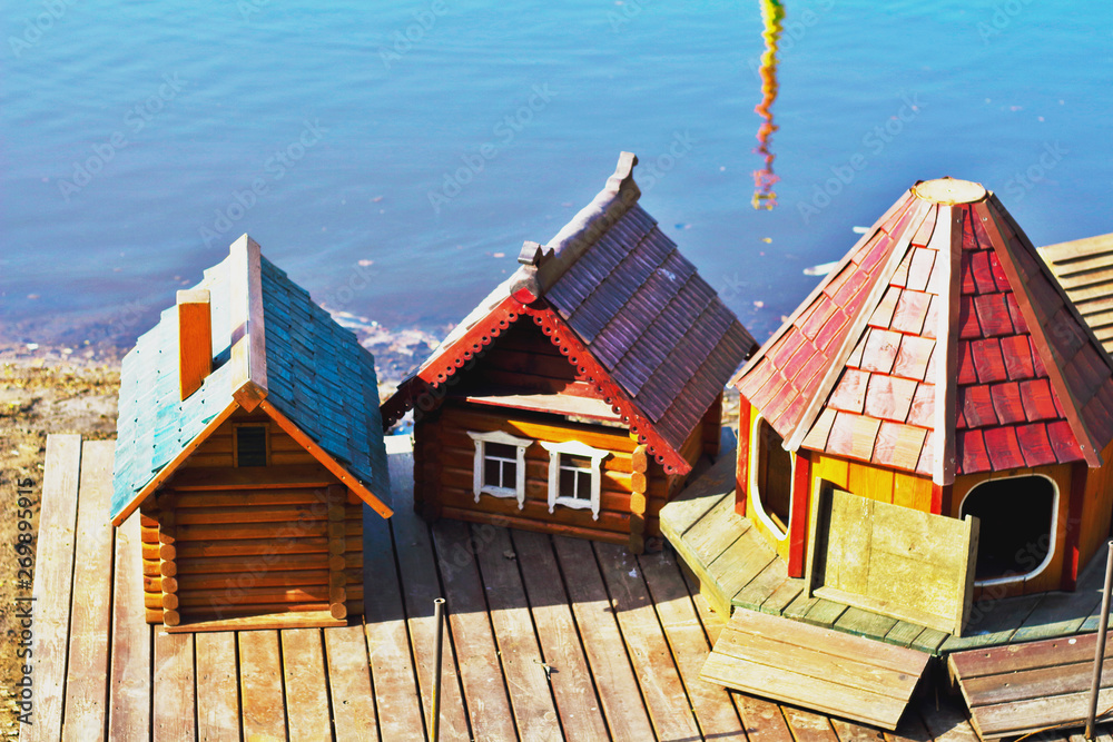 small tiny beautiful wooden colorful houses with tiles on the roof by ...