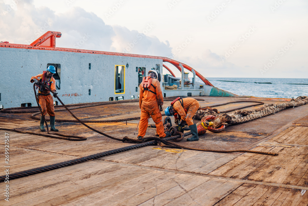 Anchor-handling Tug Supply AHTS vessel crew preparing vessel for static ...