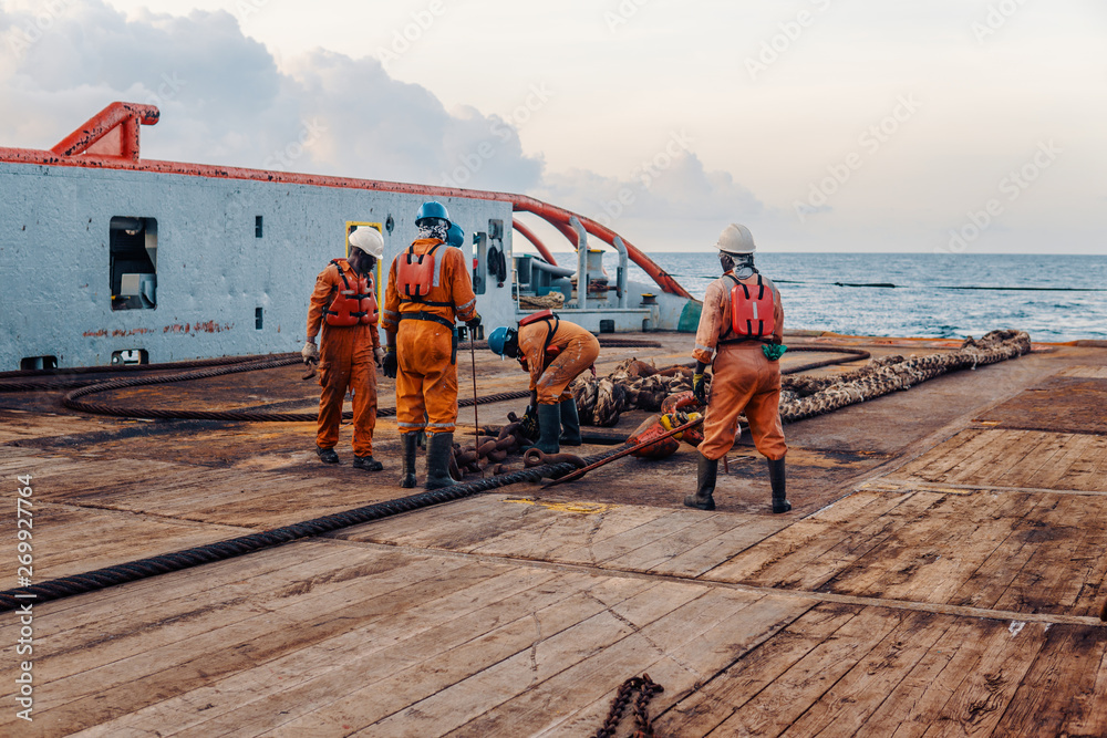 Anchor-handling Tug Supply AHTS vessel crew preparing vessel for static ...