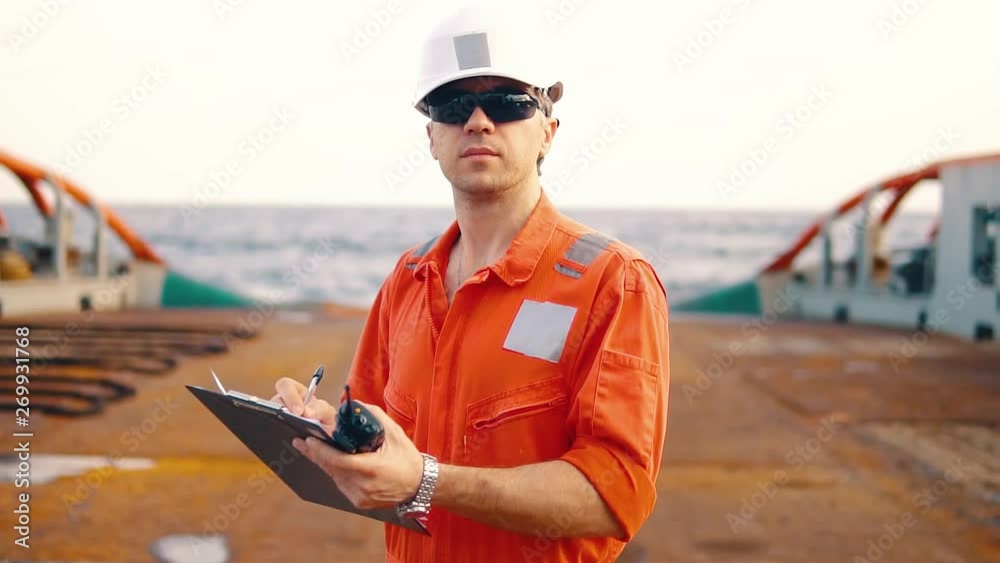 Marine chief officer or chief mate on deck of ship or vessel. He fills ...
