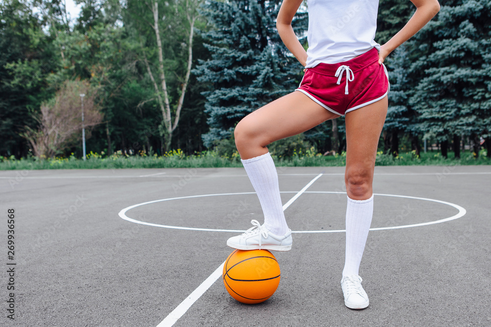 Close up wonan's feet in white sneakers and whote long socks, with a ...