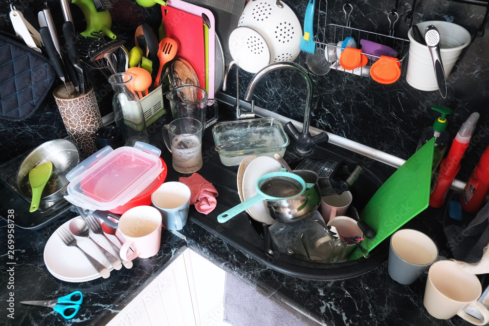 The mess in the modern kitchen. No washed dishes, pots and pans in the ...