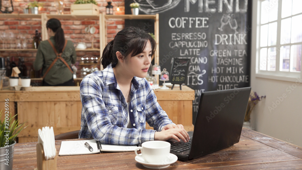 Image of happy woman using laptop while sitting at cafe bar. Young ...