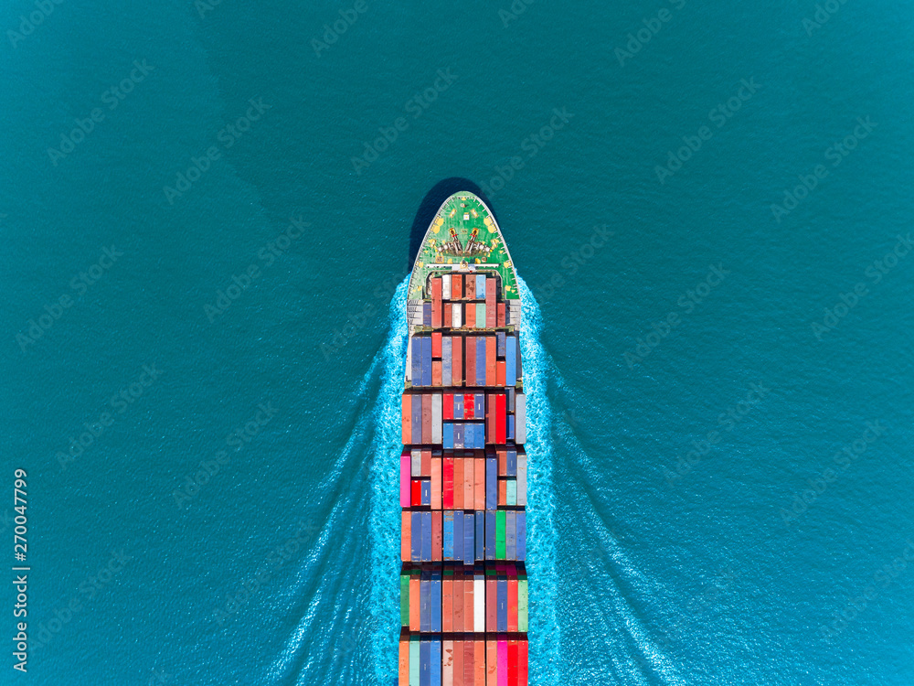 Aerial top view container ship full speed with beautiful wave pattern ...