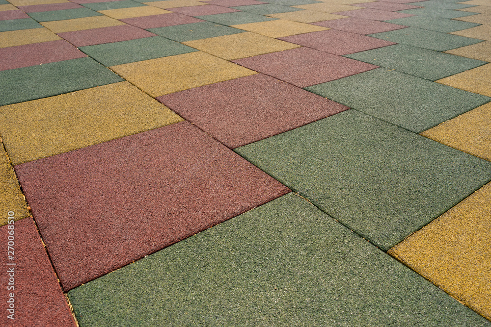 Colored rubber square paving slab for playgrounds close-up. Stock Photo ...