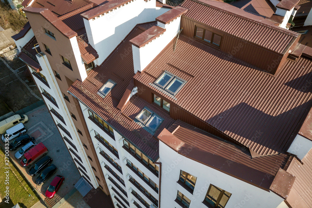 Aerial top view of new tall apartment building with annex room covered ...
