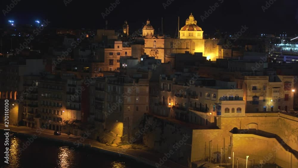 Panoramic night view of a coast line and the downtown of Valletta ...