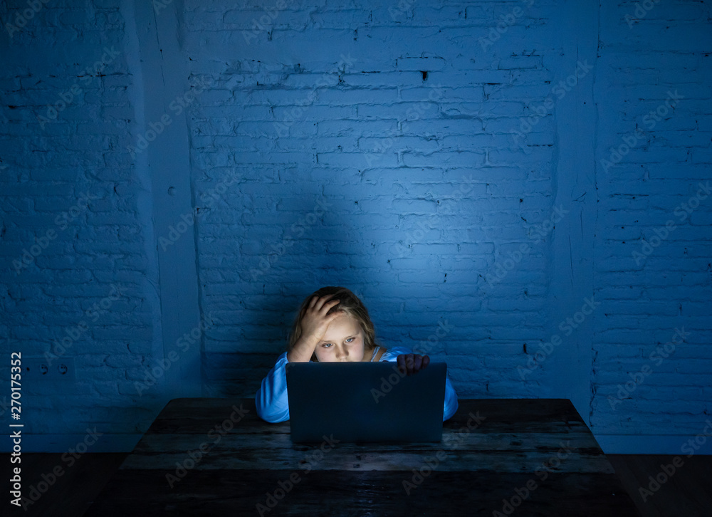 Sad young girl with laptop suffering bullying and harassment online ...