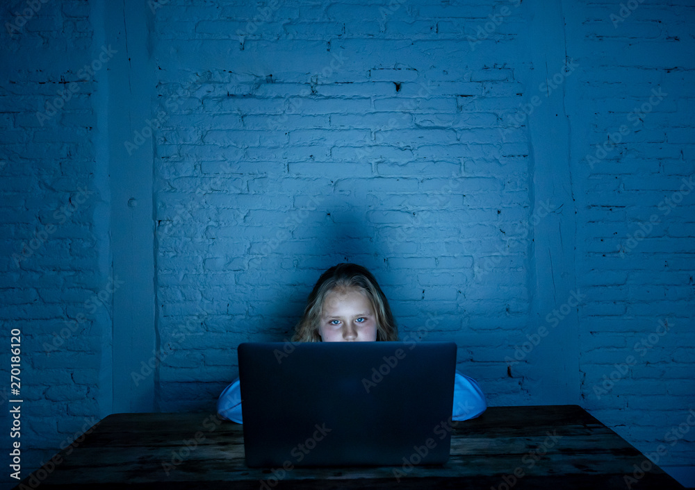 Sad young girl with laptop suffering bullying and harassment online ...