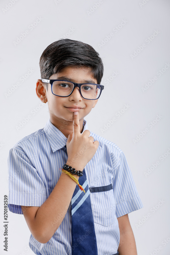 Cute little indian school boy asking / posing to keep silence, standing ...