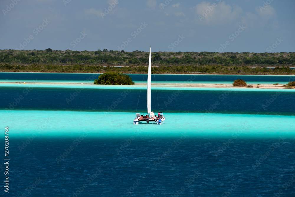 Catamaran on the azure water of the lagoon Bacalar the lake of seven ...