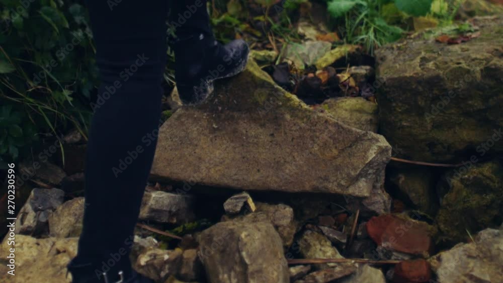 Low angle shot of unrecognizable person stepping on rocky mountain ...