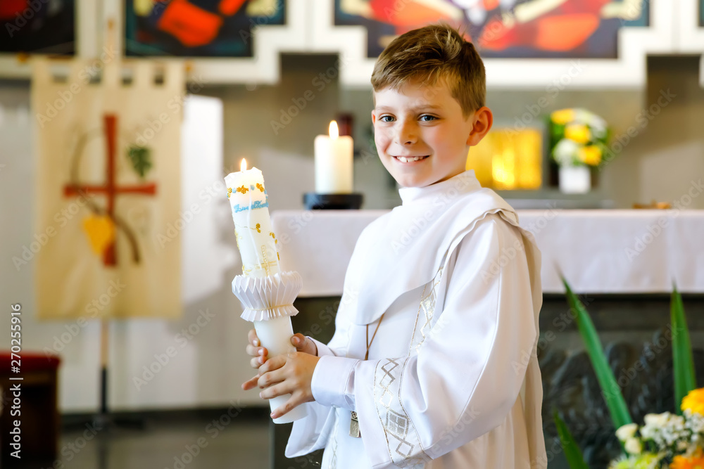 Little kid boy receiving his first holy communion. Happy child holding ...