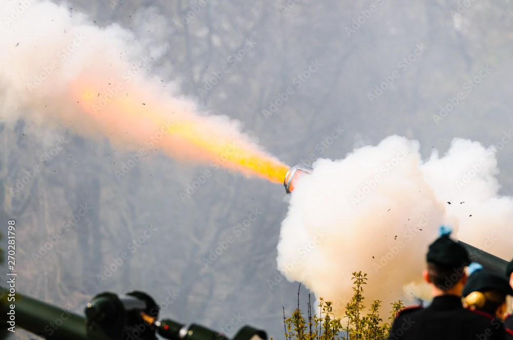 Muzzle flash from a 105mm howitzer light field gun as it fires a shell ...