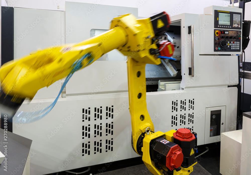 Yellow robotic hand in CNC machine center Stock Photo | Adobe Stock