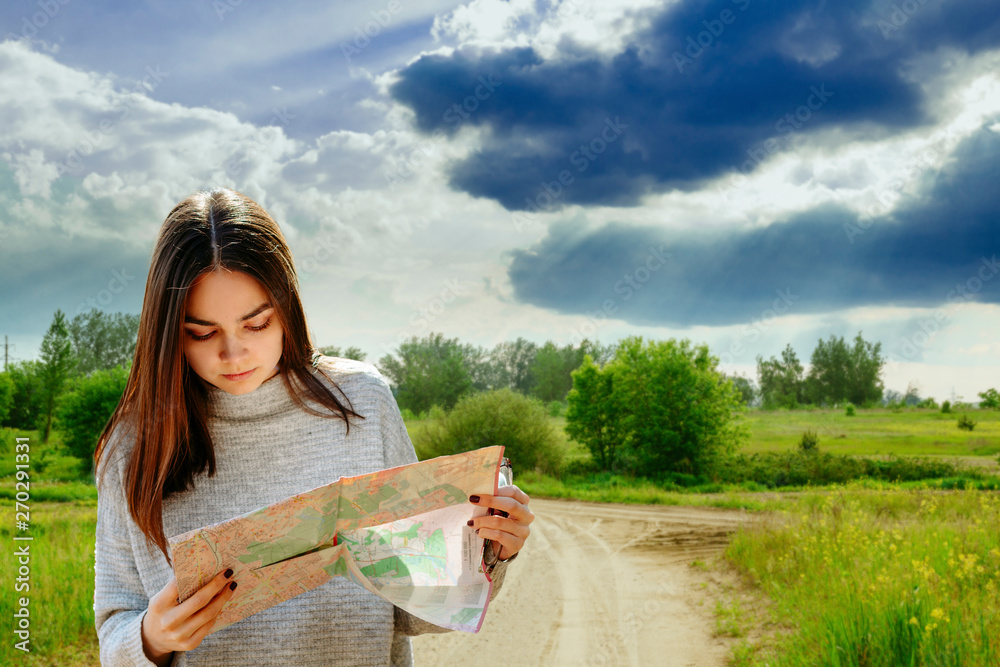 Young girl with a map in nature Stock Photo | Adobe Stock