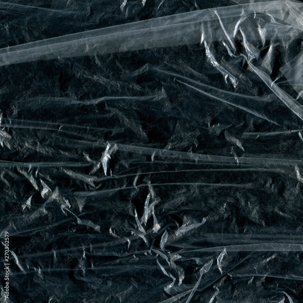 Transparent plastic wrap on the black background. Plastic bag texture ...