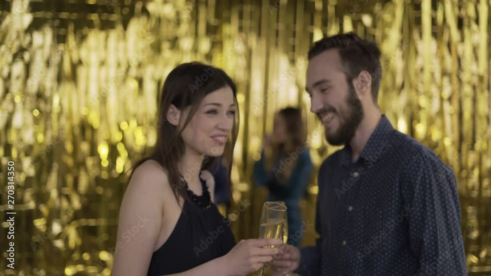 meeting at a party. man and woman meet at the disco. close-up on a gold ...