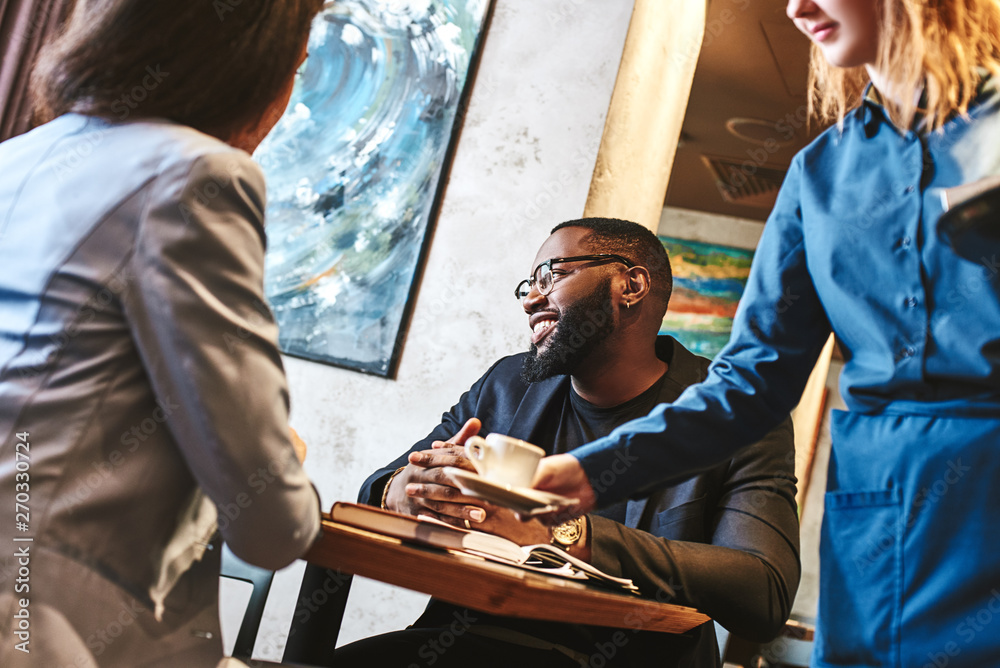 Lunch hour is the best hour of the day. Two colleagues having lunch in ...