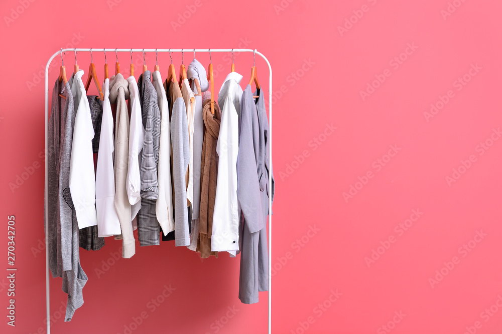 Rack with stylish clothes on color background Stock Photo | Adobe Stock