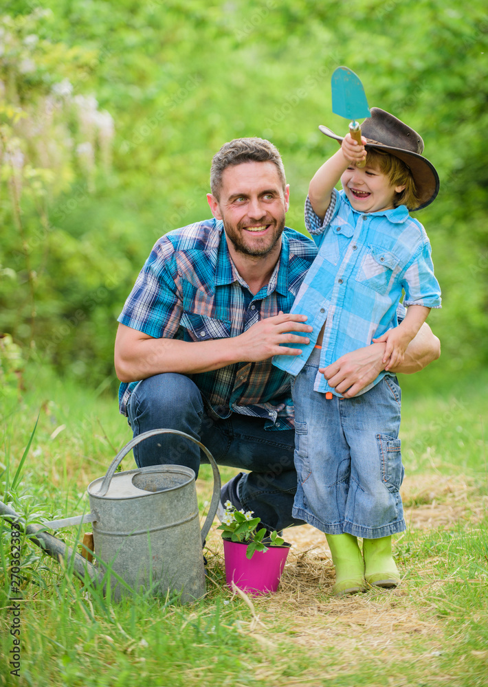 small boy child help father in farming. watering can, pot and hoe ...