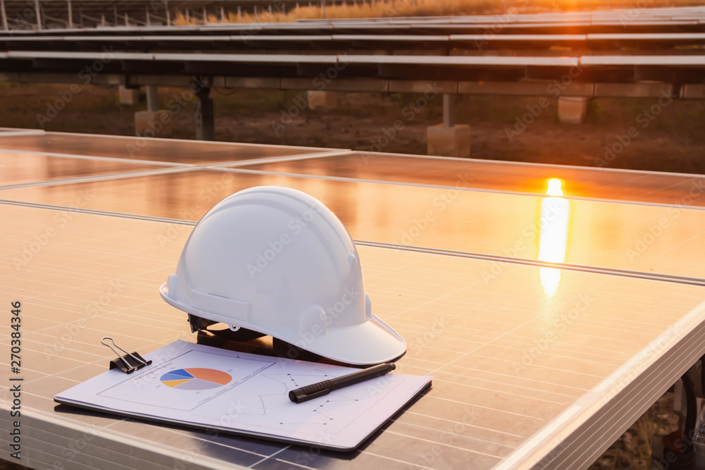 Engineers are examining the performance graph of energy production from ...