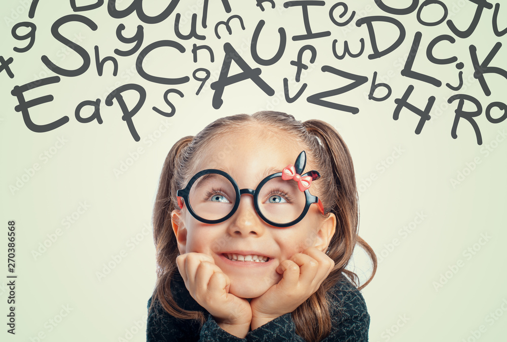 beautiful cute little girl looking at with handwritten letters of ...