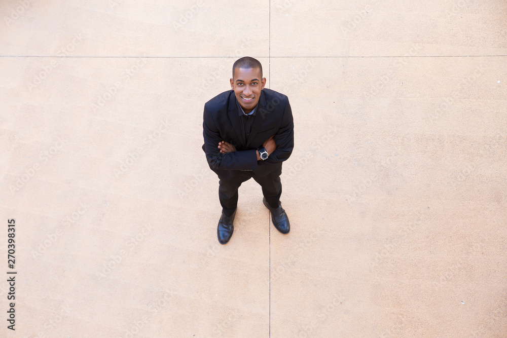 Happy confident businessman posing in office lobby. Top view of black ...