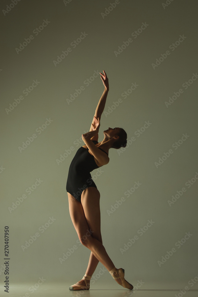 Graceful ballet dancer or classic ballerina dancing isolated on grey ...