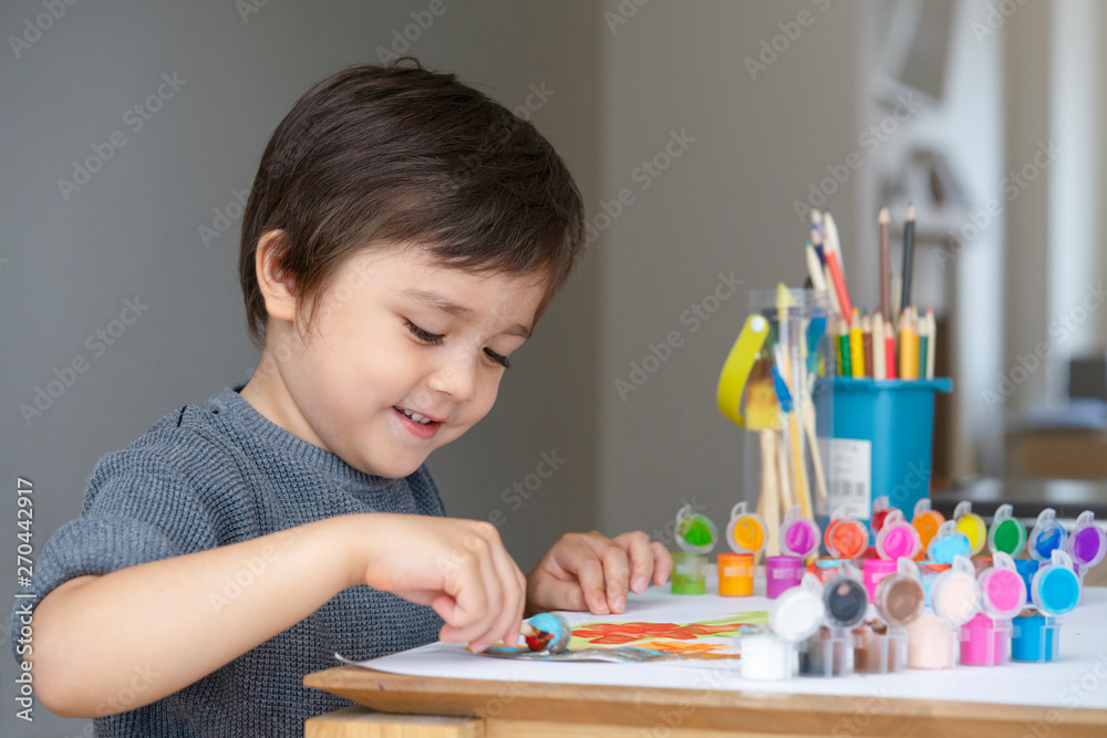 Happy boy having fun painting water colour on paper,Kid holding art ...