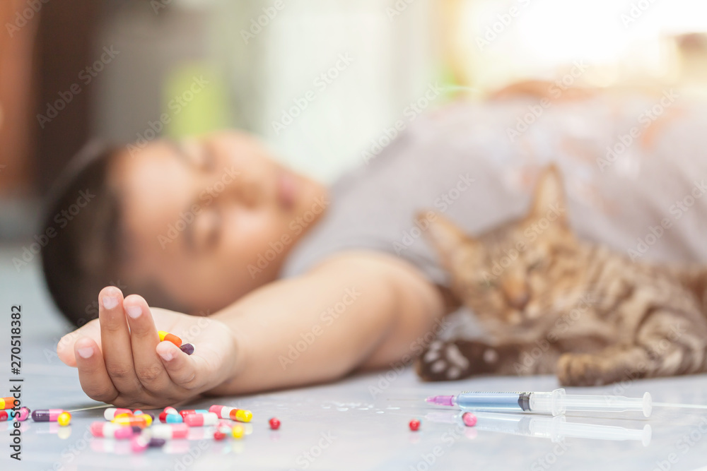 unconscious male child laying down on floor with cat beside him Stock ...