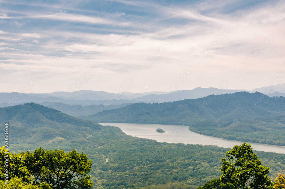 Tropical mountain landscape with foggy mountains covered with ...