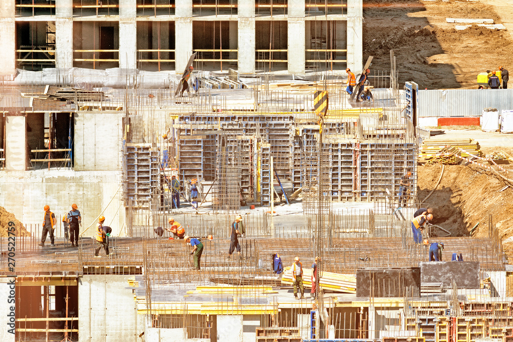 construction site overview of workers working on to build up concrete ...