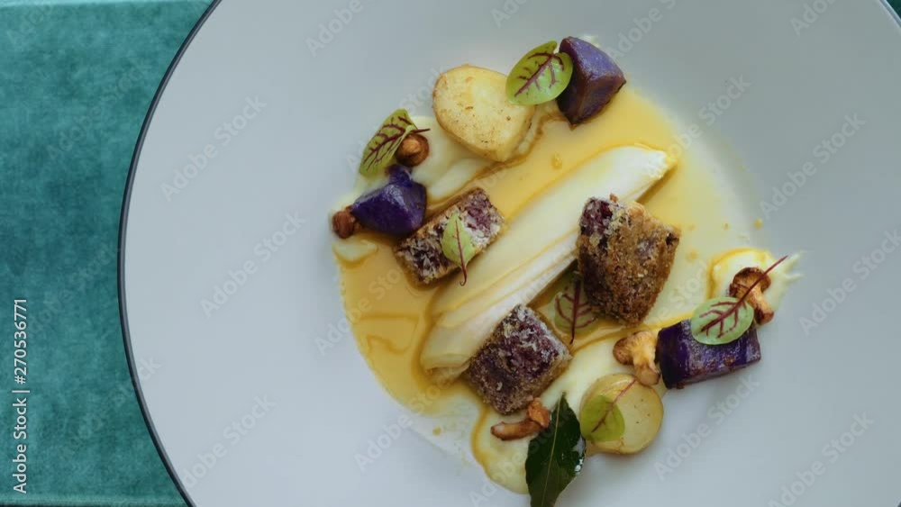 Fine dining decorated dish on a turn table, camera angle from the top ...