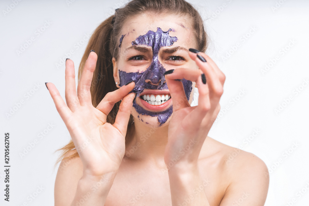 Removal of a cosmetic mask from the face of a beautiful young girl ...