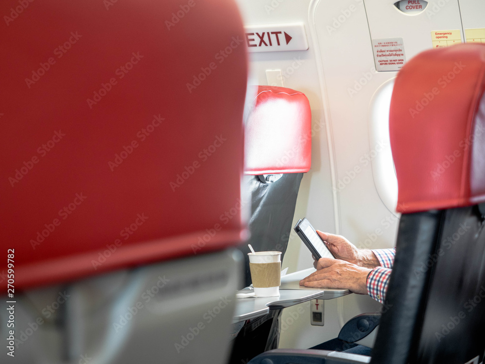 Man hands is holding and watching photos on mobile phone while flying ...