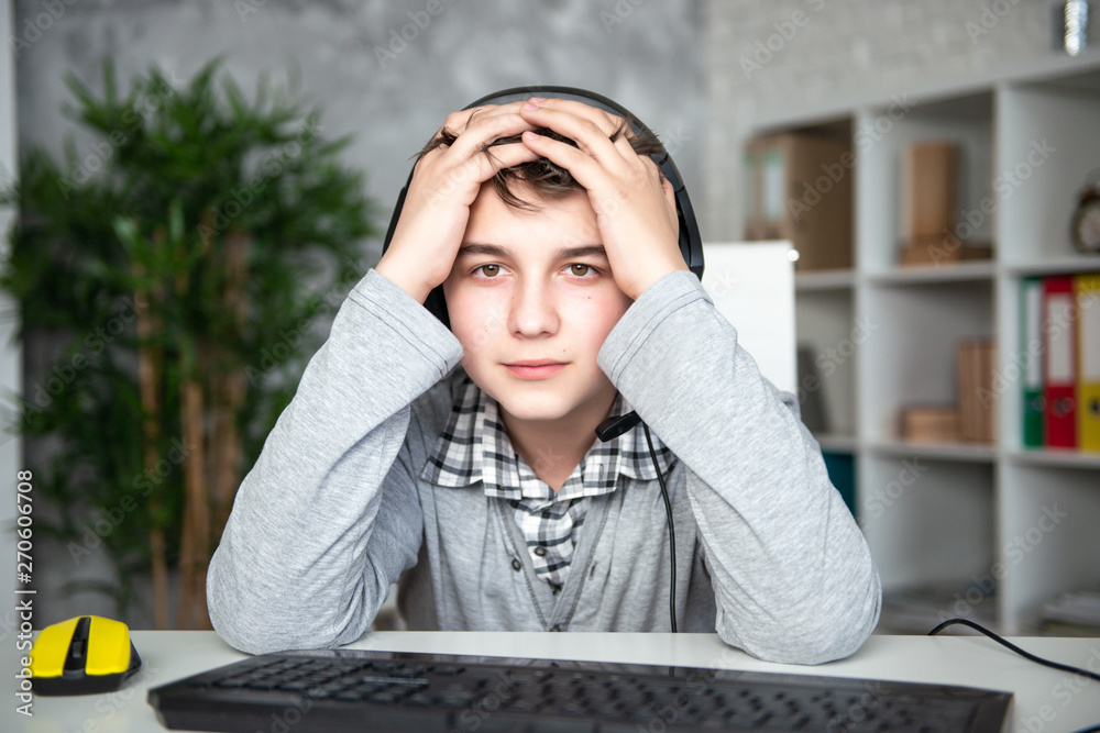 Oops, failure, loss. Teenager boy lost in a computer game. A schoolboy ...