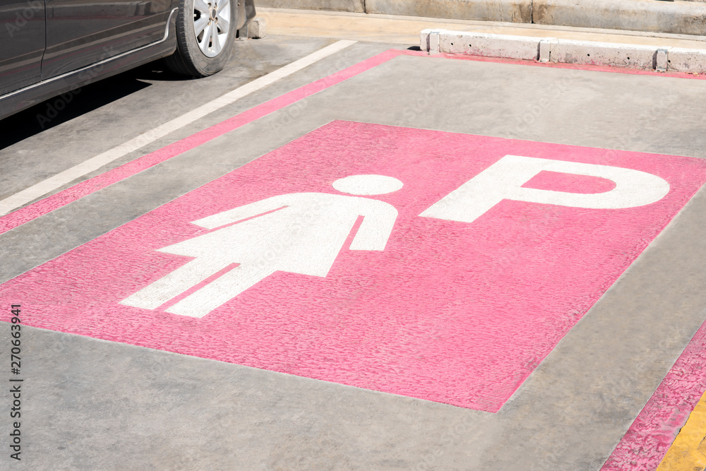 empty Lady parking lot symbol on the concrete street floor at petrol ...