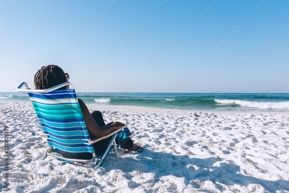Black woman relaxing on the beach Stock Photo | Adobe Stock