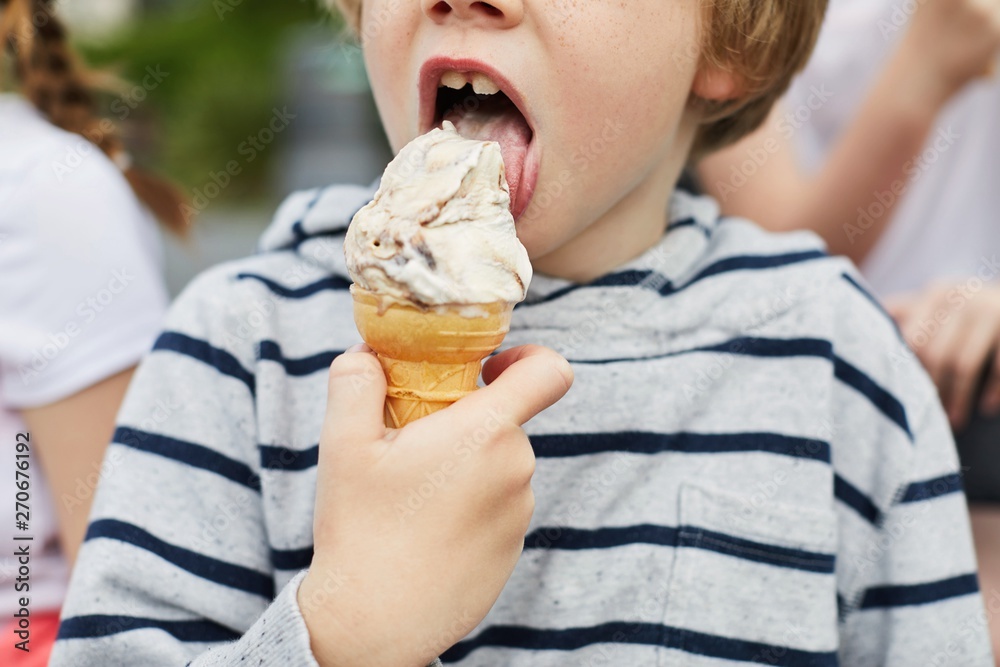 Child eating an ice cream Stock Photo | Adobe Stock