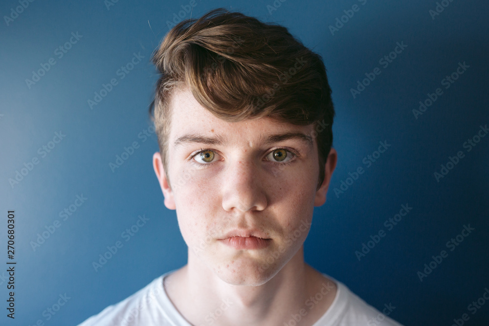 Serious teenage boy looking at camera Stock Photo | Adobe Stock