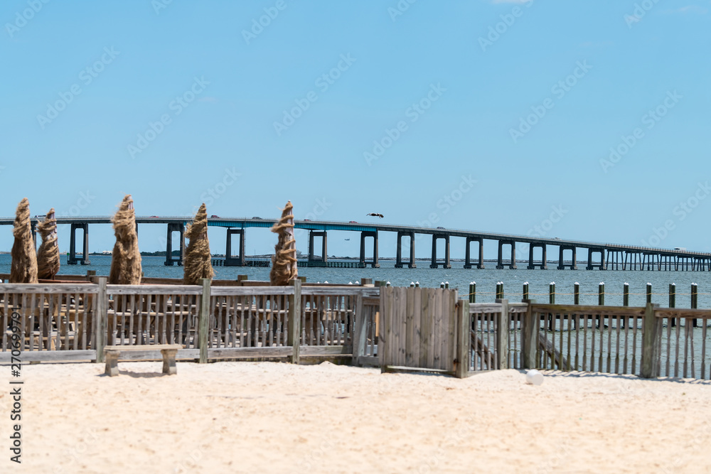 View from sand beach in Navarre on Pensacola Bay bridge with restaurant ...