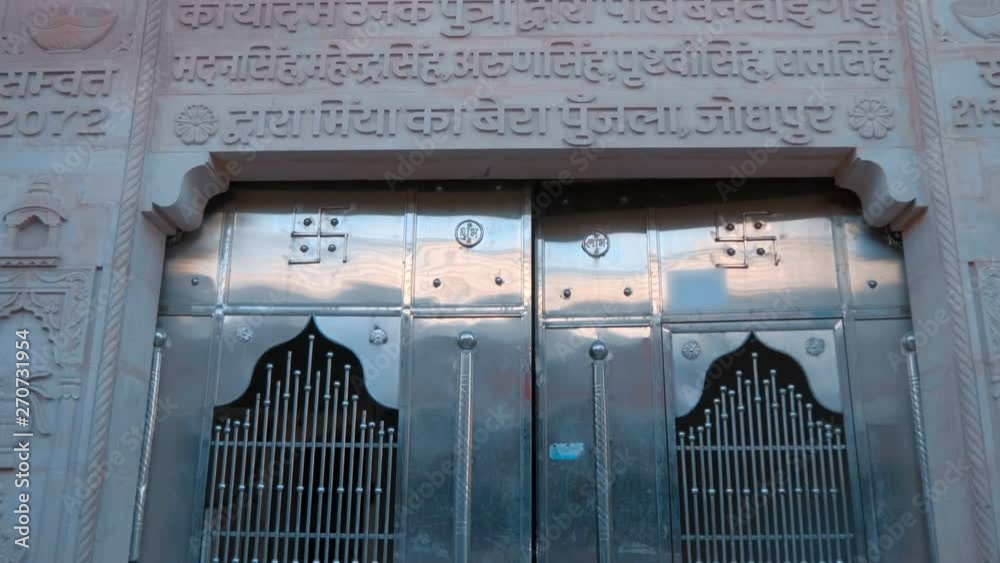 The entrance to the temple with beautiful metal shiny chrome door with ...