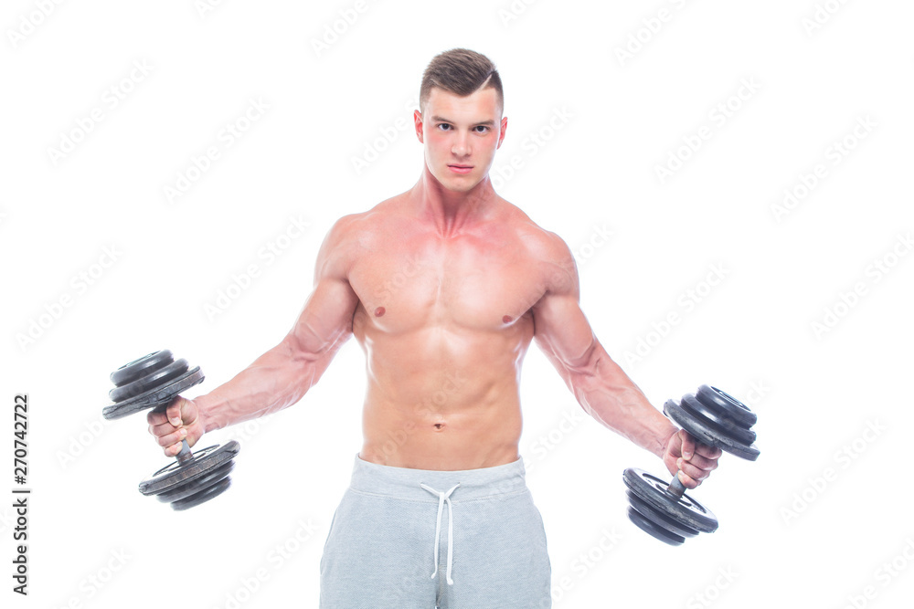 Handsome power athletic man with dumbbell confidently looking forward ...