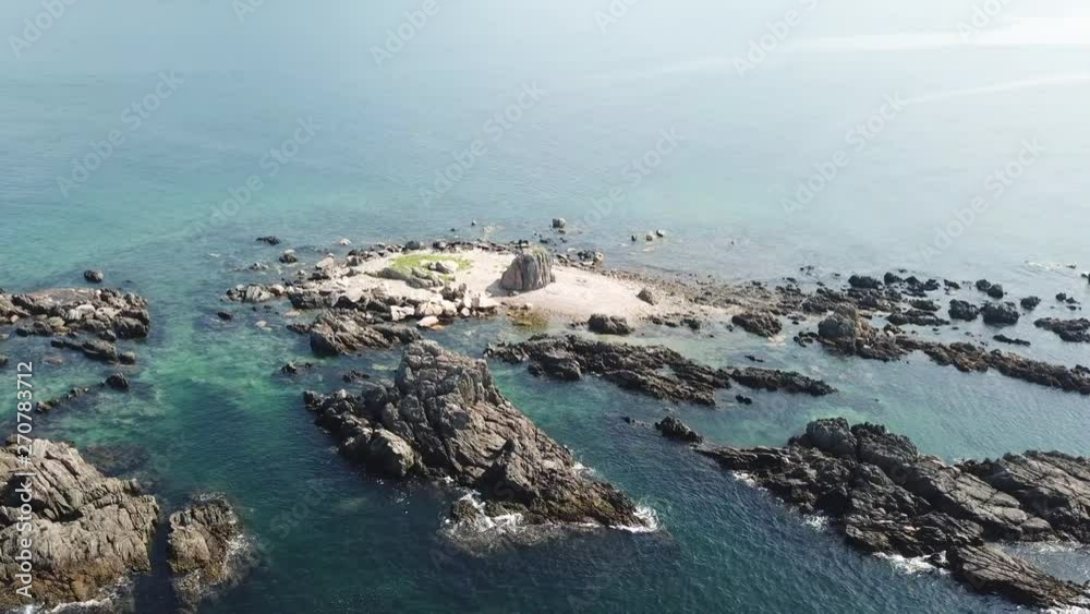 small rock island on the blue ocean upward aerial footage at nokita ...