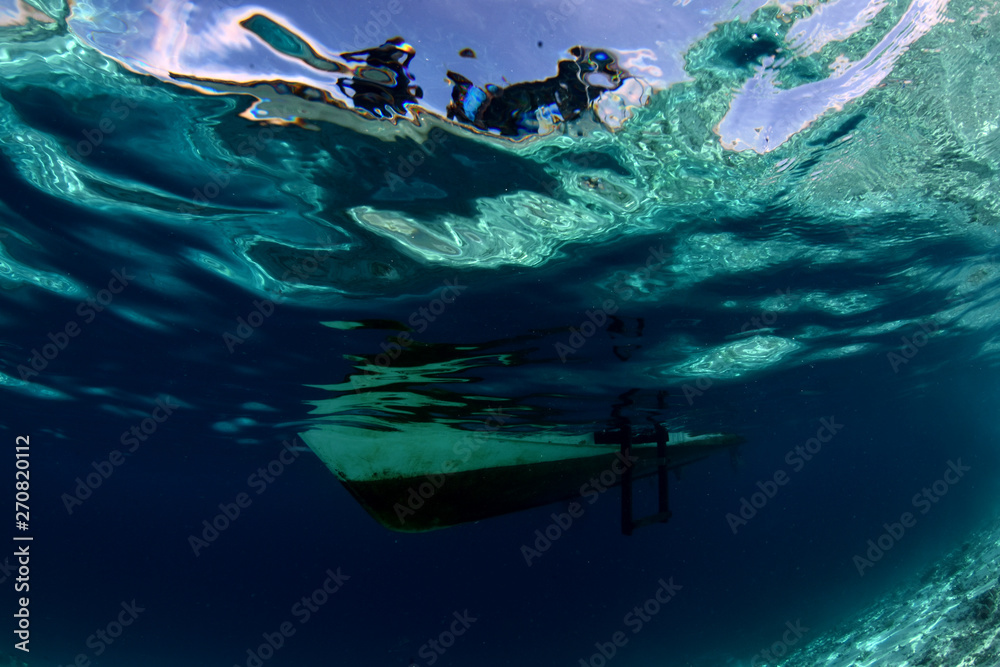 The bottom of the fishing boat view from under the water. Blue ...