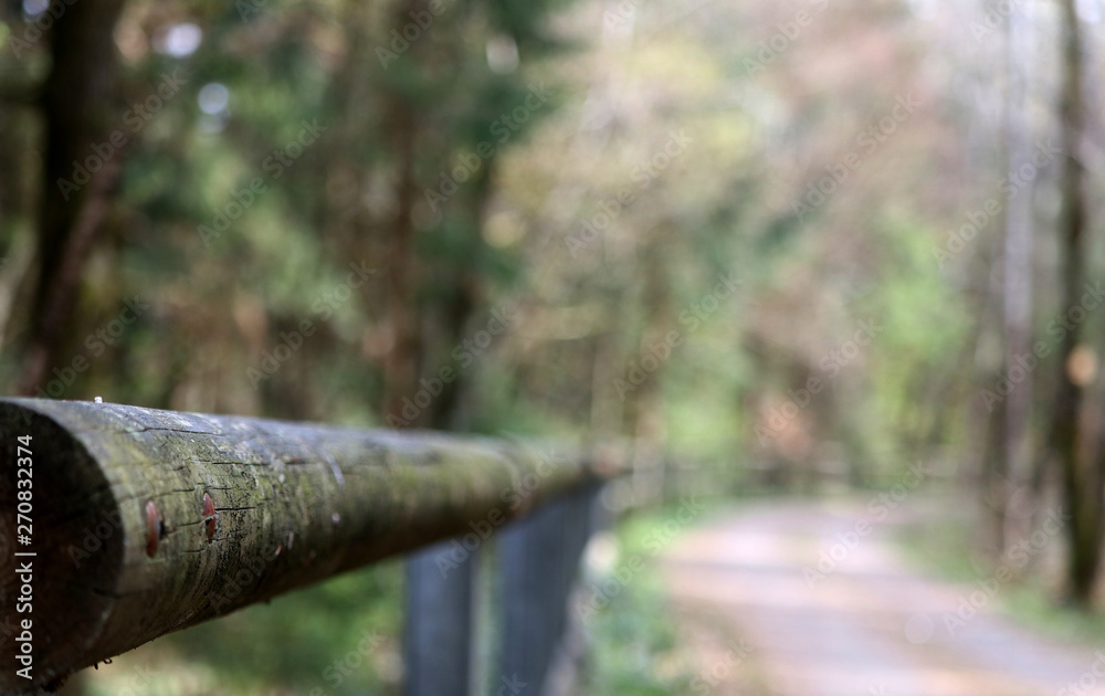 Perspective of a wooden railing along a hiking trail as a symbol of ...