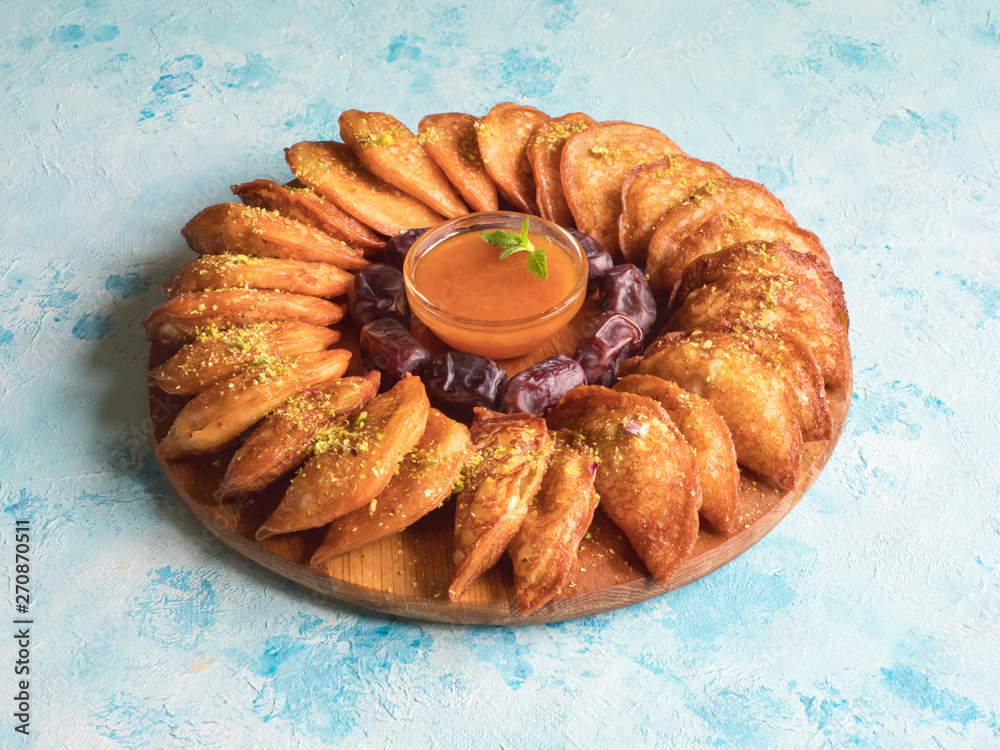 Arabic sweets. Arabian Qatayef pancake stuffed with sweet cheese and ...