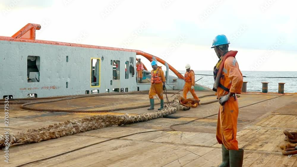 Anchor-handling Tug Supply AHTS vessel crew preparing vessel for static ...
