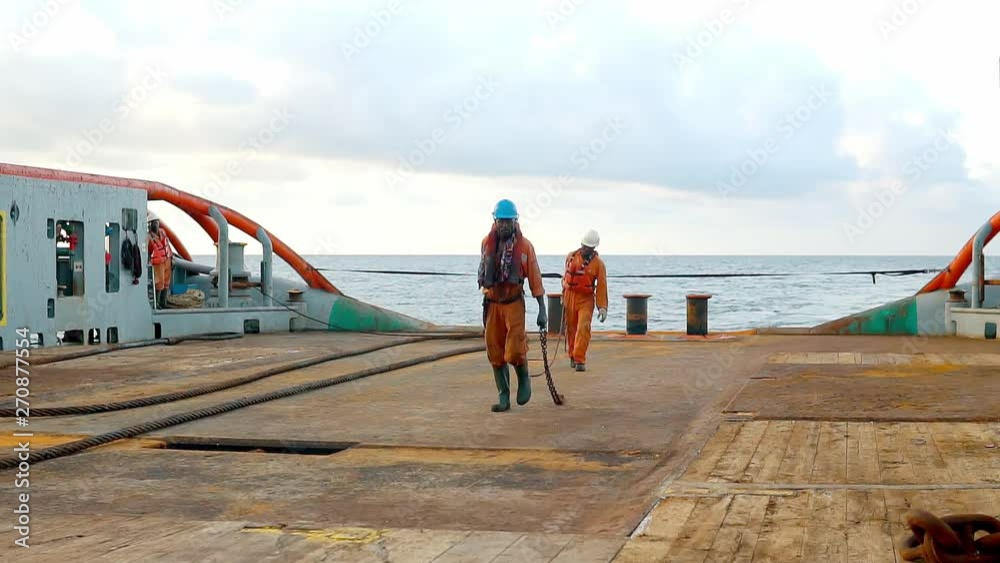 Anchor-handling Tug Supply AHTS vessel crew preparing vessel for static ...